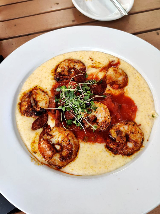 Shrimp nestled on creamy grits like royalty on a throne. The microgreens aren't just garnish&mdash;they're the crown jewels of this Southern-meets-Italian masterpiece.