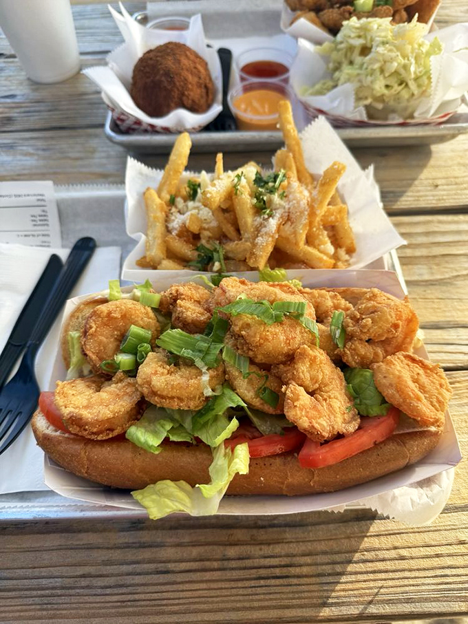 A proper shrimp po' boy should require both hands and several napkins. This beauty checks all the boxes and then creates new ones.
