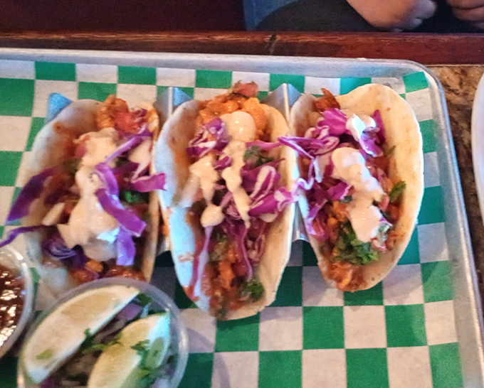 These tacos aren't just colorful &mdash; they're a flavor fiesta. Purple cabbage, creamy sauce, and perfectly seasoned shrimp come together like edible art on a checkered tray.