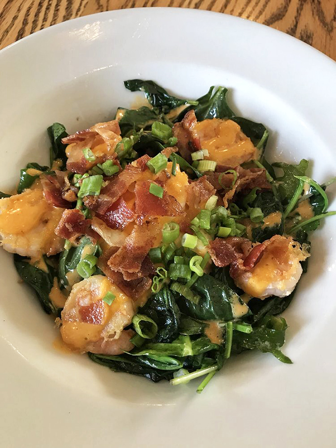 Shrimp nestled on a bed of greens with bacon crumbles and green onions&mdash;proof that healthy-ish eating doesn't have to be a punishment.