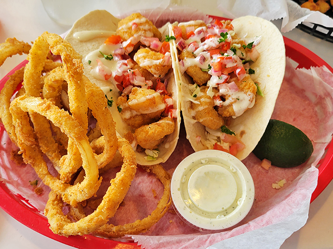Shrimp tacos paired with golden onion rings create the kind of lunch that ruins all others.