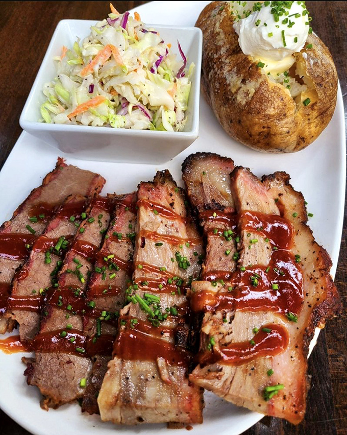 Brisket sliced and ready for its close-up, with that telltale pink smoke ring that separates the barbecue masters from the pretenders. The loaded baked potato isn't too shabby either.
