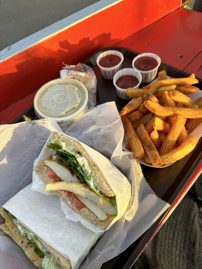 Fresh seafood sandwich wrapped in paper &ndash; nature's perfect to-go package. Add cold lemonade and suddenly Monday feels like a vacation day.