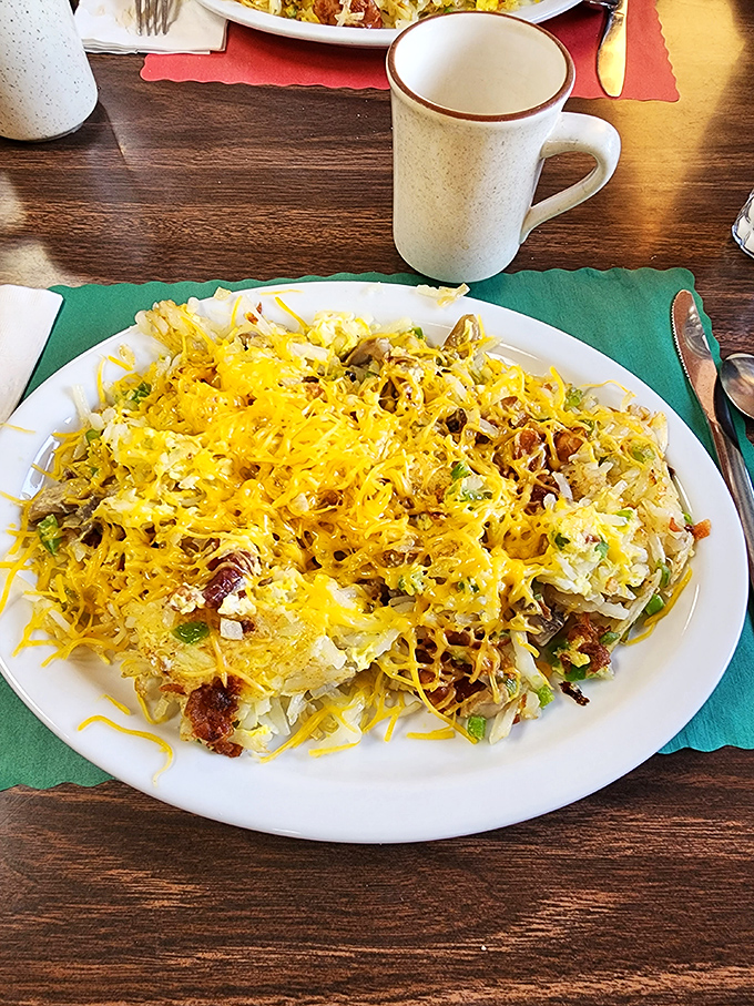 This mountain of hash browns, eggs, and melted cheese isn't just breakfast &ndash; it's edible architecture designed for maximum satisfaction.