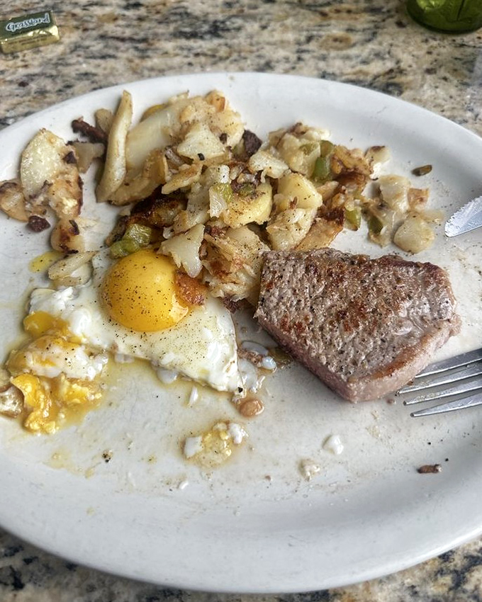 Home fries that dance with seasoning, eggs cooked just right, and a steak that means business. This plate doesn't mess around.