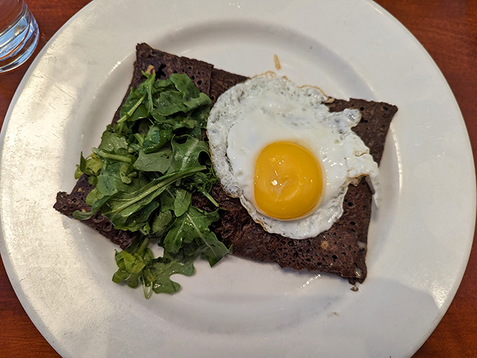 Breakfast perfection on a plate: a buckwheat galette topped with a sunny-side-up egg that's practically winking at you.