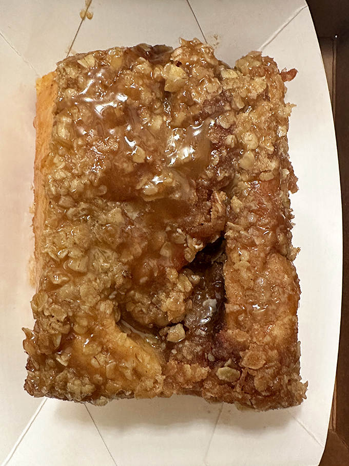 Architectural marvel meets breakfast bliss. This sticky bun defies both gravity and willpower with its towering presence and glistening caramel coating.