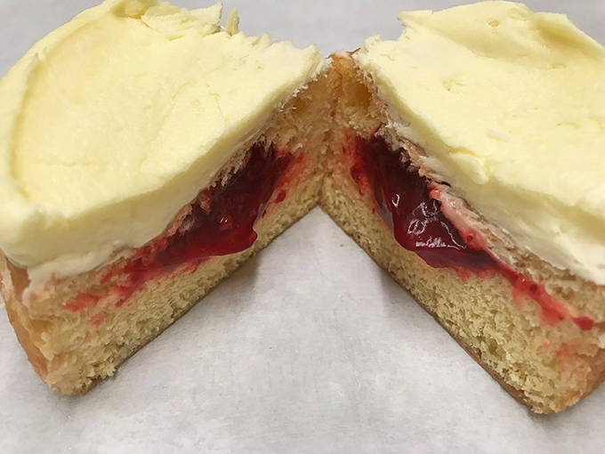 Cut one open and witness the miracle: strawberry filling nestled inside pillowy dough, topped with vanilla icing that melts on your tongue.