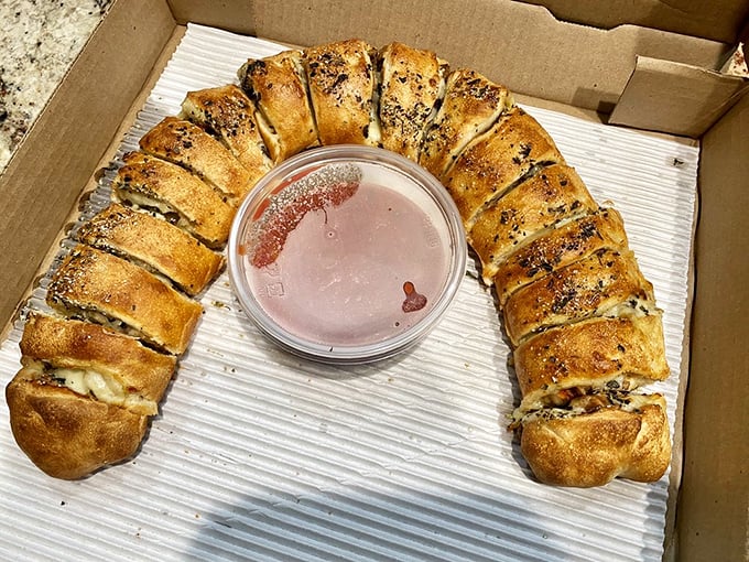 The stromboli arrives like an edible horseshoe of good fortune, stuffed with treasures and ready to be dunked in that perfect marinara.