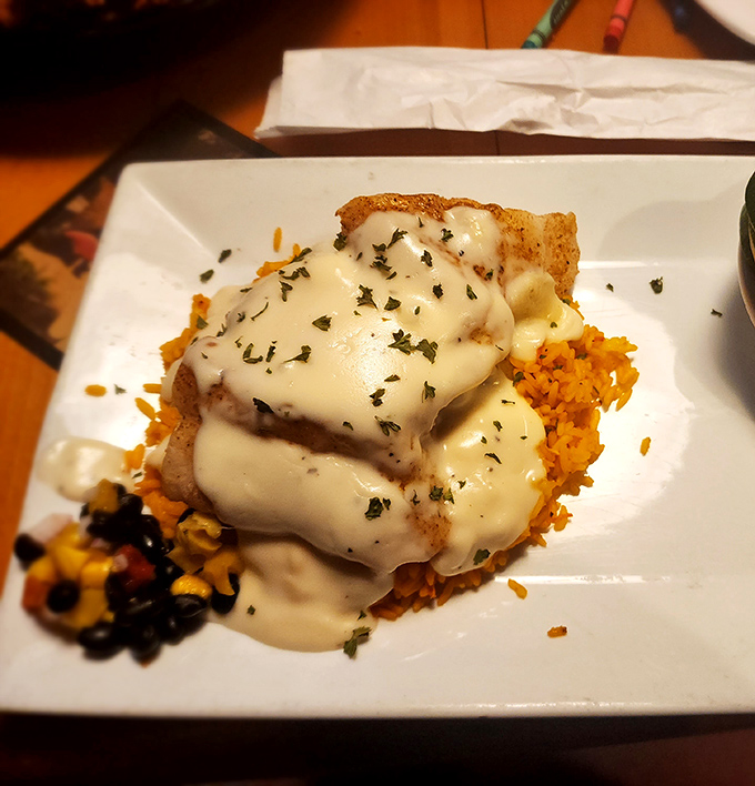 This isn't just fish&mdash;it's a cheese-smothered masterpiece resting on a bed of Spanish rice that would make abuela proud.