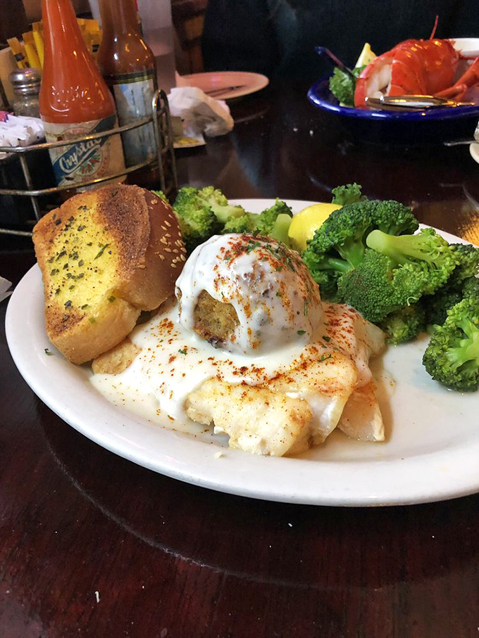 Stuffed grouper smothered in creamy white sauce with a side of perfectly steamed broccoli. This isn't a meal, it's a maritime masterpiece.