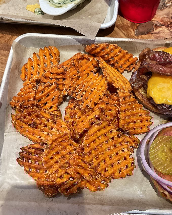 Sweet potato waffle fries that achieve the impossible: crispy exterior, fluffy interior, and enough seasoning to make you forget ketchup exists.