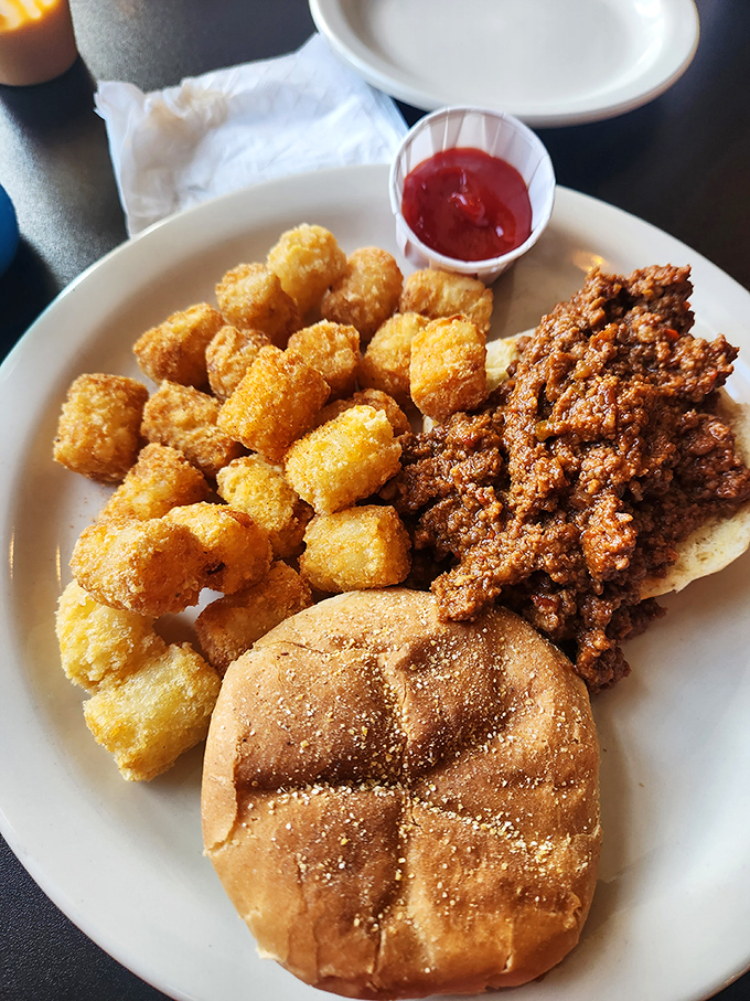 Comfort food's ultimate sidekick—these golden-brown tater tots and savory loose meat sandwich create the kind of plate that childhood dreams and adult cravings are made of.