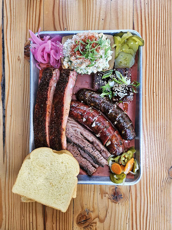 Not so much a meal as a carnivore's dream sequence: ribs, sausage, and brisket sharing a tray with house-made sides and the obligatory white bread.