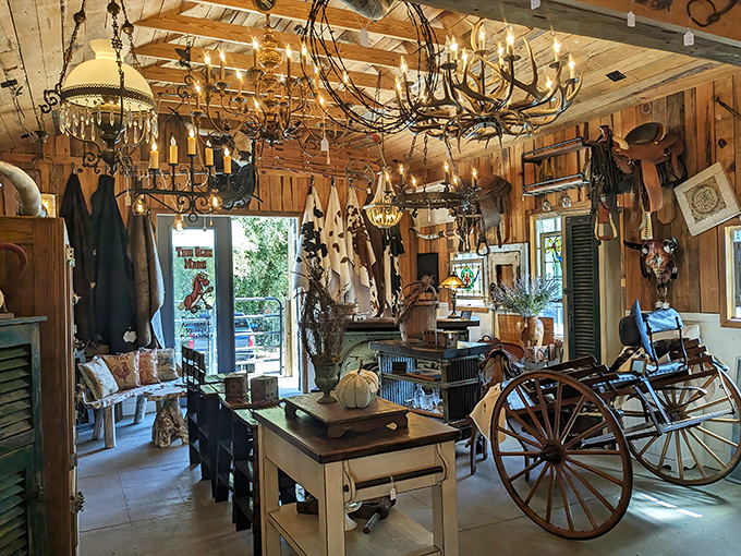 Rustic wood walls and wagon wheels create the perfect backdrop for country-chic treasures, where chandeliers cast a warm glow over carefully curated Americana.