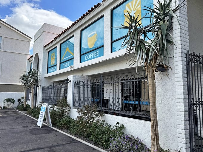 Spanish-style architecture meets desert landscaping in this retail oasis. The blue signage pops against white walls like a refreshing swimming pool in Phoenix's heat.