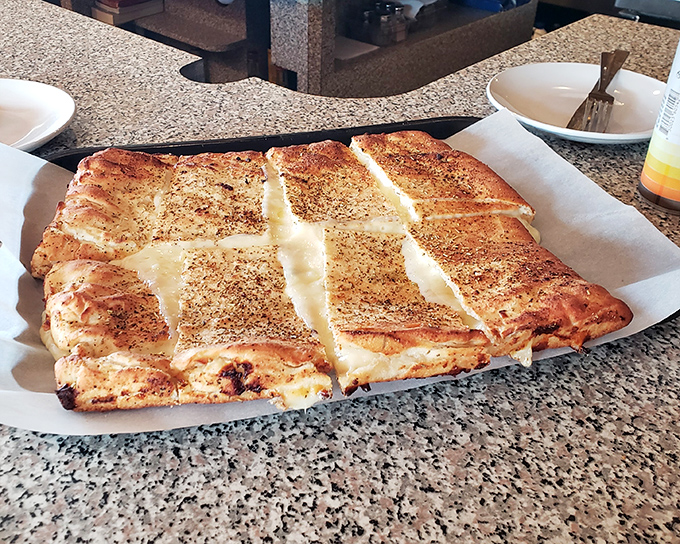 The white pizza arrives like a blank canvas painted with cheese&mdash;a masterpiece that would make even the Mona Lisa smile.