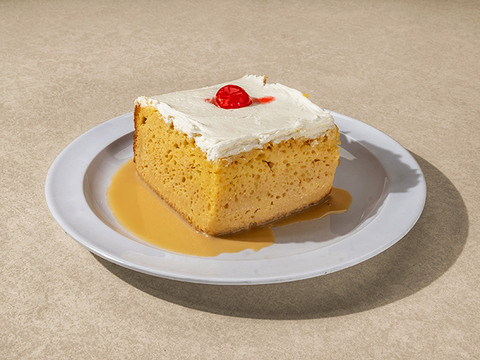 This Tres Leches cake isn't just moist – it's practically oceanic. The crowning cherry feels like a captain's flag claiming dessert territory.