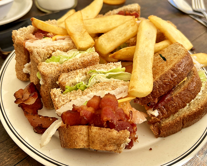 The club sandwich: three layers of proof that sometimes the classics endure because they're simply perfect. Those fries aren't just a side&mdash;they're co-stars.