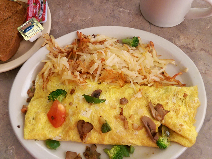 Breakfast perfection on a plate &ndash; this omelet stuffed with fresh vegetables and topped with crispy hash browns is morning nirvana.