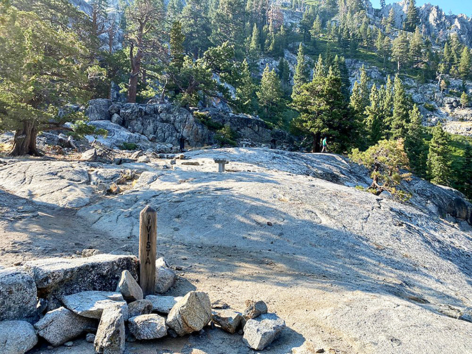 Granite playground: Sun-warmed slabs of Sierra Nevada bedrock create natural viewing platforms where hikers pause to soak in the mountain majesty.