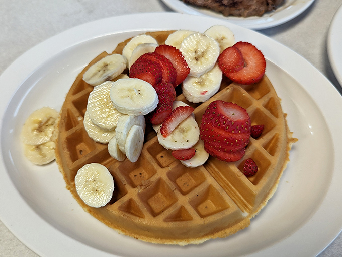 Waffle architecture at its finest – a perfect grid foundation supporting the noble alliance of strawberries and bananas.
