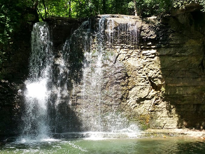Sunlight plays across the falling water, creating a natural light show against limestone walls that have witnessed centuries of Ohio's evolving story.