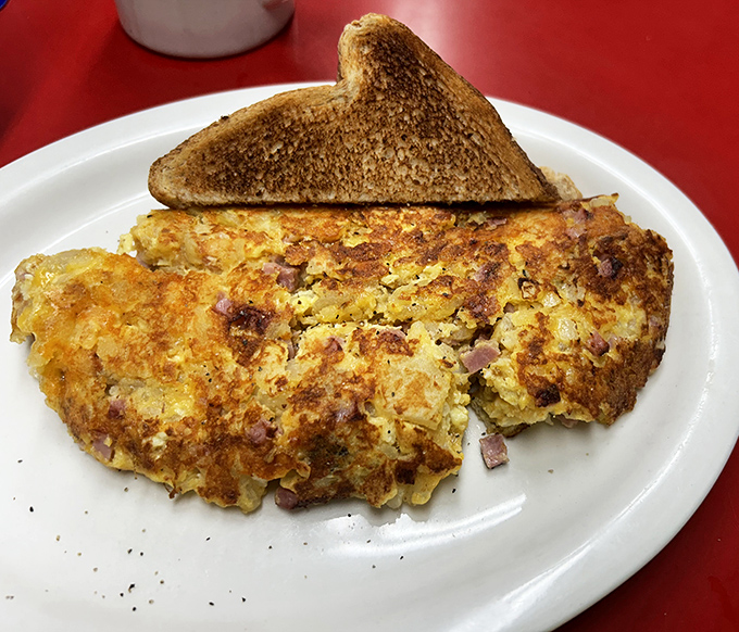 This isn't just an omelet&mdash;it's a masterpiece of morning architecture, with ham and cheese melted into perfect harmony.