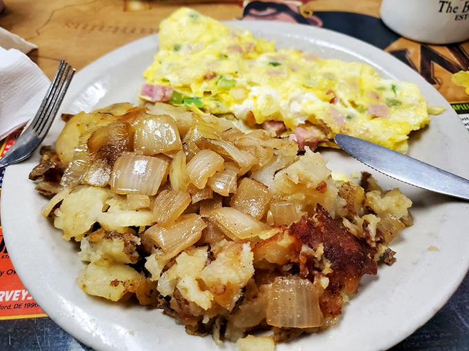 Breakfast alchemy at its finest&mdash;home fries crisped to perfection alongside a ham-studded Western omelet. The kind of plate that makes conversation optional.