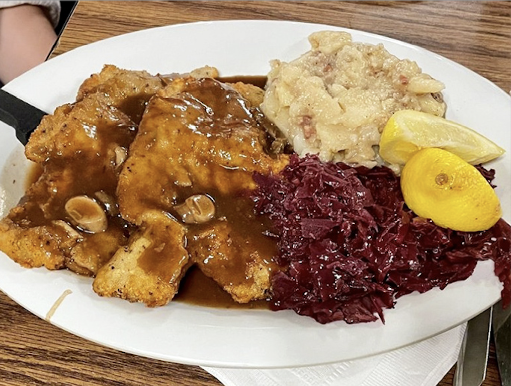 Crispy schnitzel cutlets golden as autumn leaves, accompanied by traditional German sides done right.