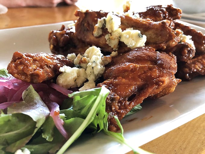 These aren't just wings&mdash;they're crispy, sauce-lacquered flavor bombs topped with crumbled blue cheese that make sharing an act of true friendship.