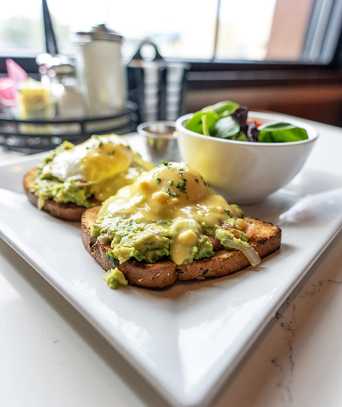 Avocado toast that even your skeptical uncle would approve of&mdash;perfectly poached eggs and hollandaise creating breakfast nirvana.