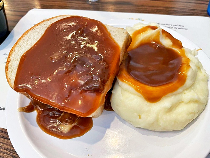 This open-faced beef sandwich drowning in rich gravy proves that comfort food knows no boundaries.