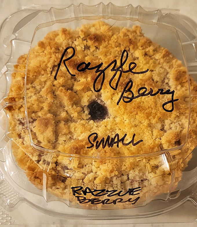 The crumble topping on this razzelberry pie looks like it's been sprinkled by dessert fairies. Berry treasures hide beneath that golden crown.