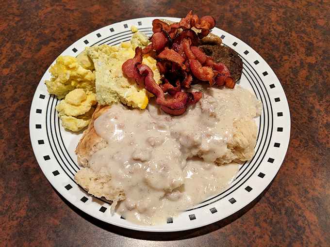 Biscuits and gravy: the breakfast that hugs you from the inside. That crispy bacon is doing a victory lap around a plate of pure comfort.