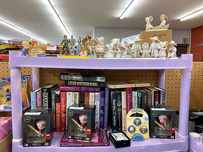 Literary treasures and collectible figurines share shelf space in perfect harmony. Those Cincinnati Reds bobbleheads are just waiting for a superfan's man cave.