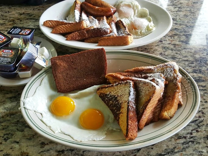 The holy trinity of breakfast: golden hash browns, perfectly crisp scrapple, and eggs with that sunrise-yellow yolk ready to break.