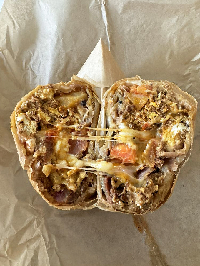 The breakfast burrito cross-section reveals the architectural genius within&mdash;layers of flavor held together by melty cheese mortar.
