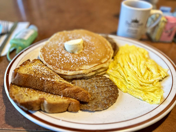 The classic American breakfast trifecta – fluffy pancakes, savory sausage, and scrambled eggs sharing a plate like old friends at a high school reunion.