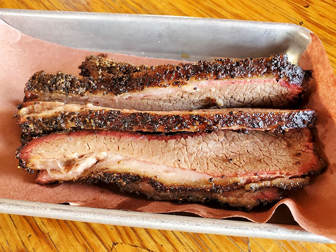 Brisket sliced so perfectly you could use it to teach geometry &ndash; the smoke ring is less "optional feature" and more "diploma from meat university."
