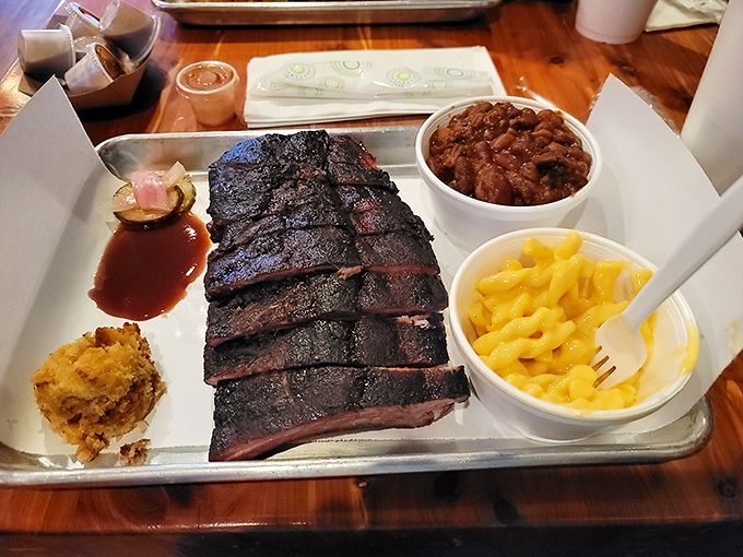 Brisket with that obsidian bark that whispers of patient smoking, alongside mac and cheese that practically winks at you.