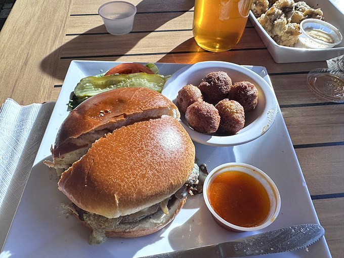 A burger that requires both hands and a strategy. Notice those perfectly crisp sides&mdash;this is a kitchen that understands the importance of textural contrast.
