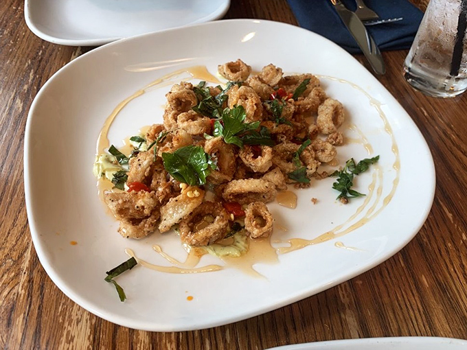 Crispy calamari that shatters with each bite, brightened with fresh herbs and a drizzle that ties everything together. No rubber bands here, folks.