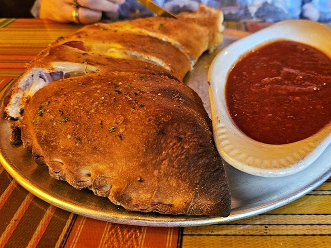 The calzone: where pizza decides to fold in on itself and become something even more magnificent, with a side of tangy sauce for good measure.