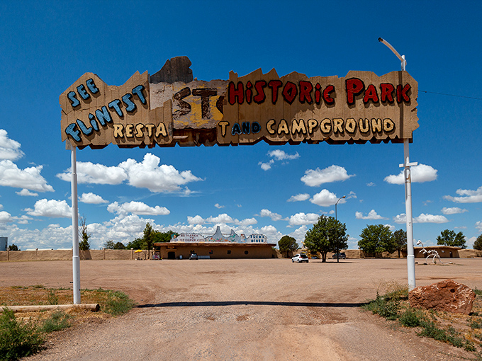 The "See Flintstone's Historic Park" sign promises a journey back to a time that never existed but somehow feels nostalgic anyway.