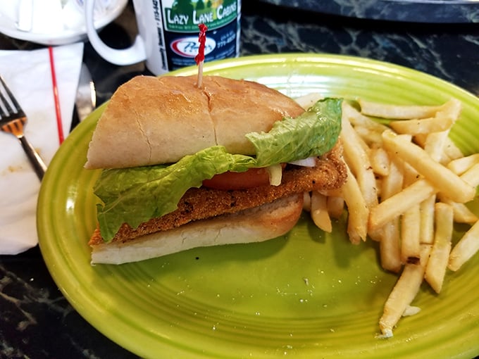 Sometimes simplicity speaks volumes. A perfectly crisp fish sandwich on a vibrant plate with golden fries&mdash;comfort food that hits all the right notes. 