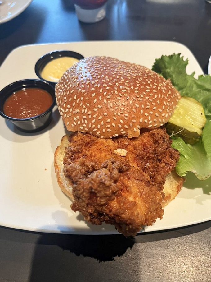 Fried chicken sandwiches are the unsung heroes of any great burger joint. This golden-brown masterpiece comes with dipping sauces that demand attention.