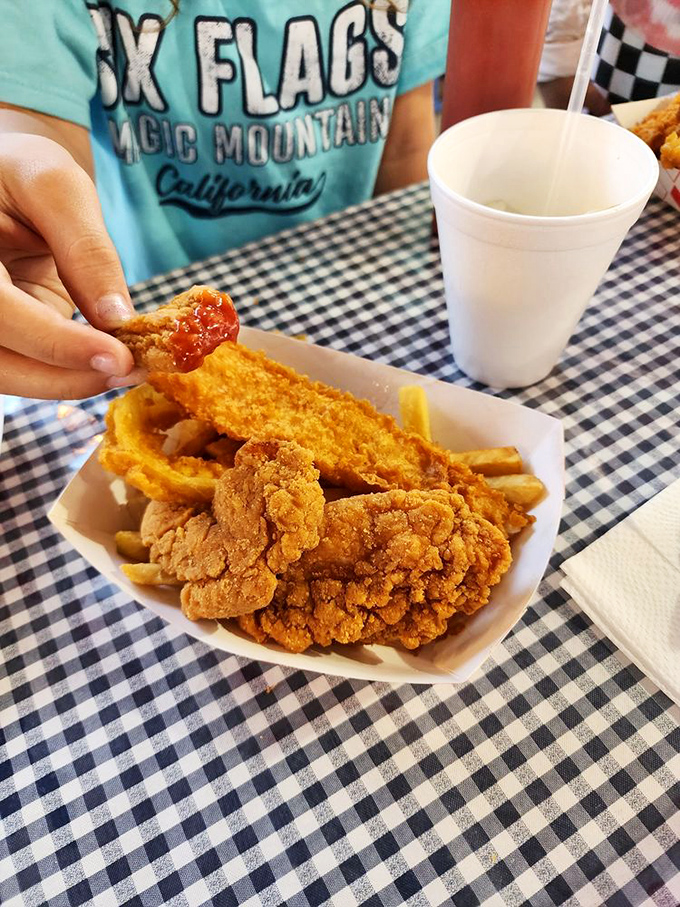 Even the chicken has seafood envy here, sporting the same impeccable golden crust that makes you wonder if everything tastes better near water.