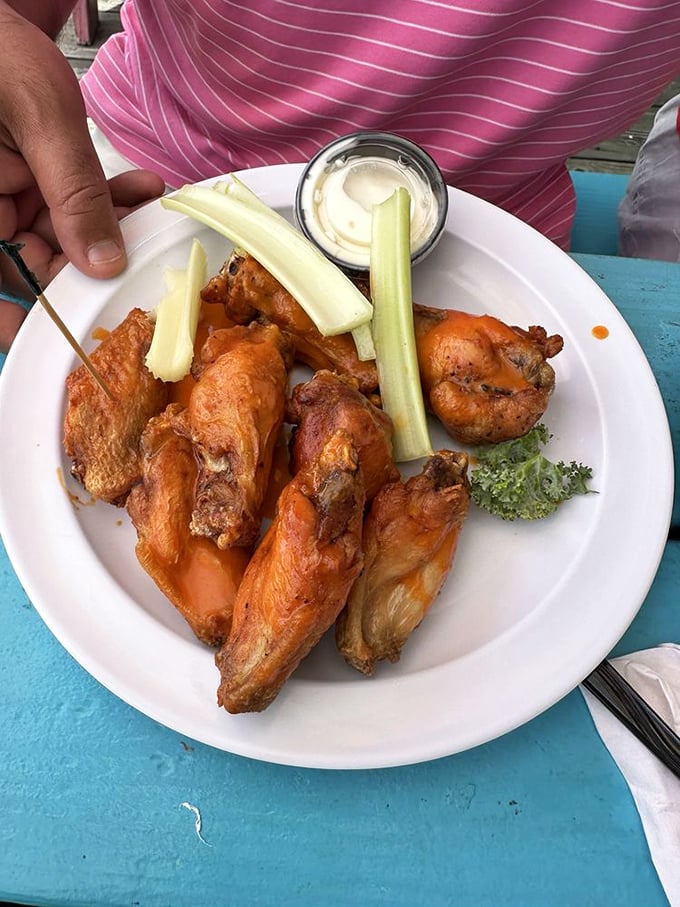 Wings so perfectly crisp they'd make Buffalo jealous, served with the holy trinity of accompaniments: celery, dip, and cold beer (just out of frame).