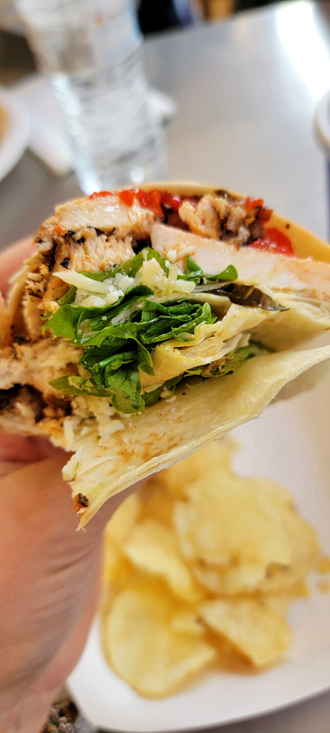 A wrap so fresh and vibrant it makes you question your relationship with sad desk lunches. Those greens actually look like they've seen soil recently!